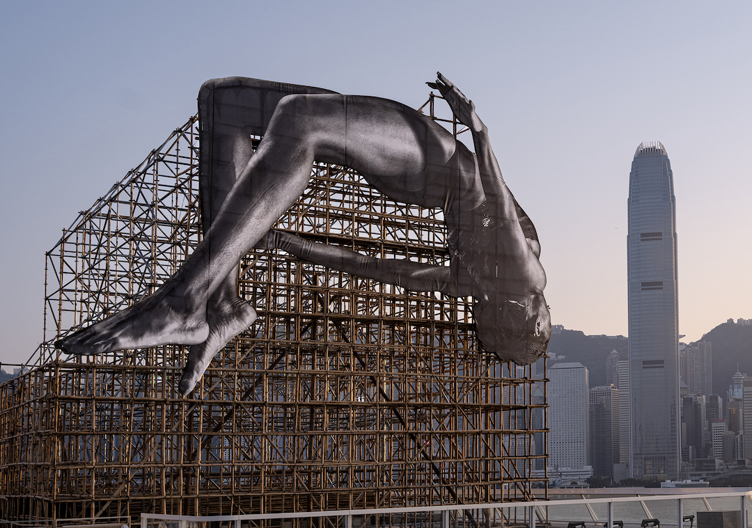High-Jumping Athlete Arches Over Scaffolding In Public Illusion In Hong ...